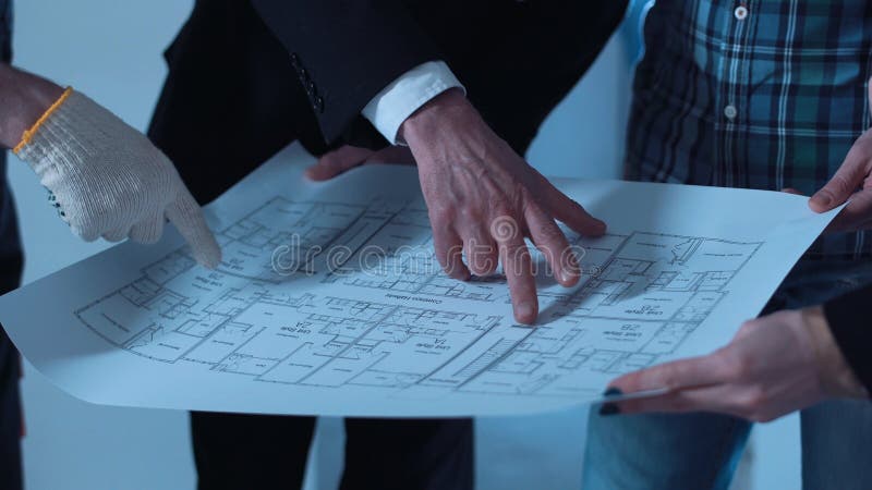 The Group of Workers Discussing Blueprints Stock Photo - Image of ...