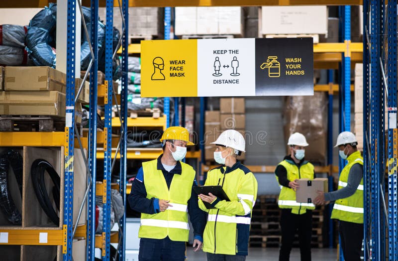 Group of Workers with Face Mask Working Indoors in Warehouse ...