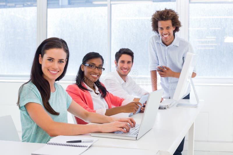 Group of Workers Hard at Work and Smiling To the Camera Stock Photo ...