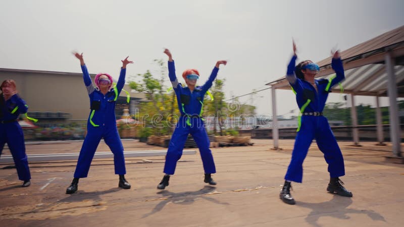 Group of Workers in Uniforms Doing a Coordinated Dance Outdoors Stock ...