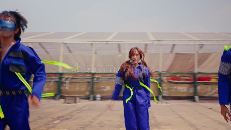 Group of Workers in Uniforms Doing a Coordinated Dance Outdoors Stock ...