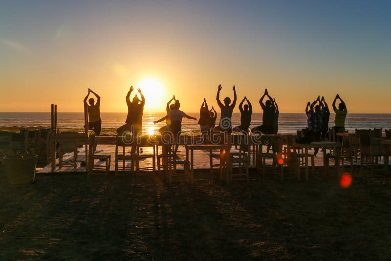Group Doing Yoga Exercises on the Beach at Sunset Editorial Photography ...