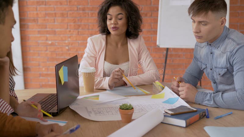 A Group of Young Architects and Engineers are Working on a Building ...
