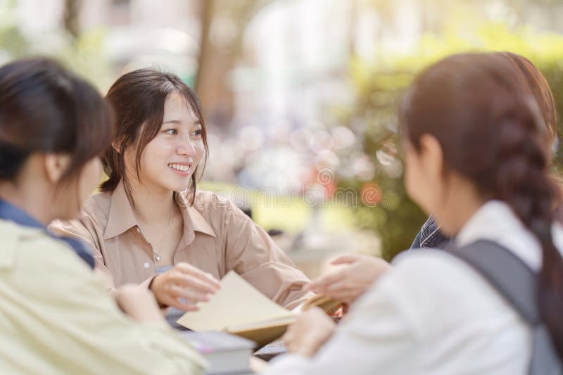 Group of Young Asian College Students Sitting on a Bench in a Campus ...