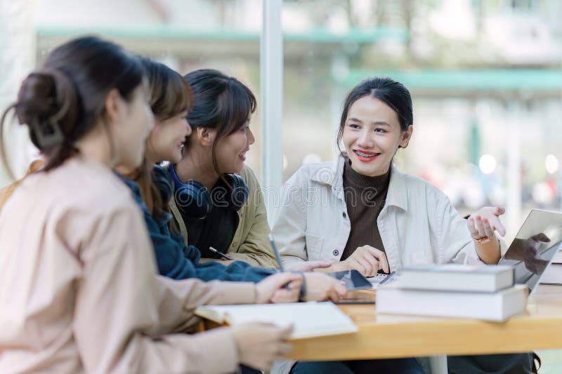Group of Young Asian College Students Sitting on a Bench in a Campus ...