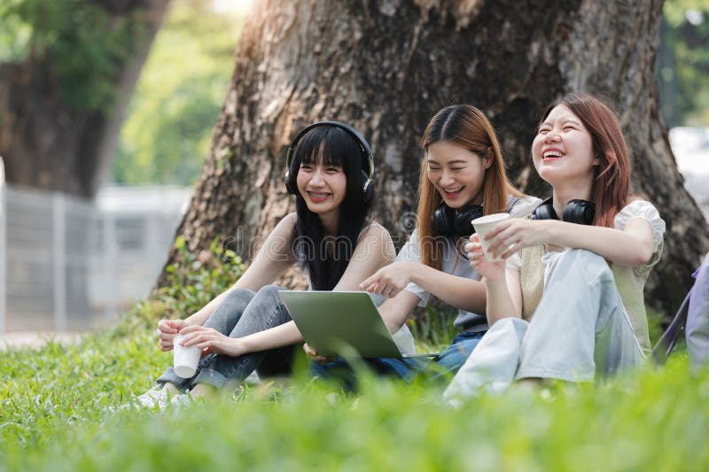 Group of Young Asian Students Collaborating Outdoors at University ...