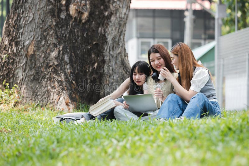 Group of Young Asian Students Collaborating Outdoors at University ...