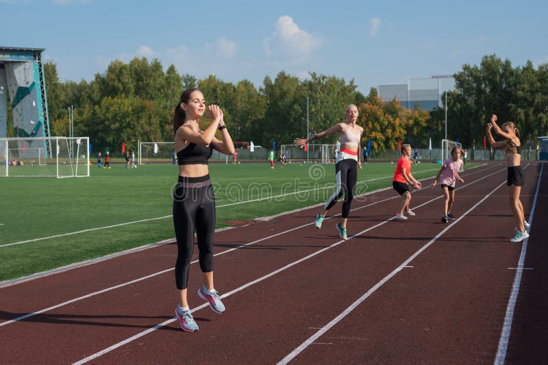 Group of Young Athletes Training at the Stadium Stock Photo - Image of ...