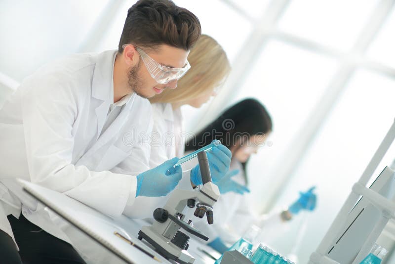 Group of Young Biologists Sitting at the Laboratory Table Stock Image ...