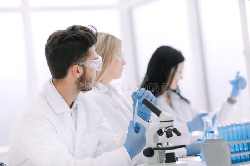 Group of Young Biologists Sitting at the Laboratory Table Stock Photo ...