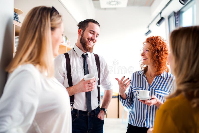 A Group of Young Business People on Coffee Break in Office Kitchen ...