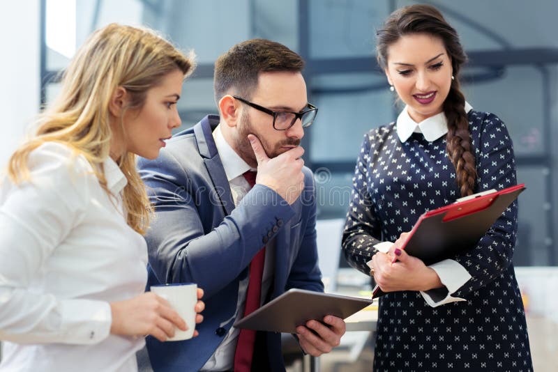 Group of Business People Discussing the Latest Details about the ... Group of Business People Discussing the Latest Details about the ...