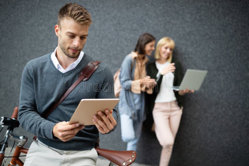 Group of Young Business People Holding Different Digital Devices ...