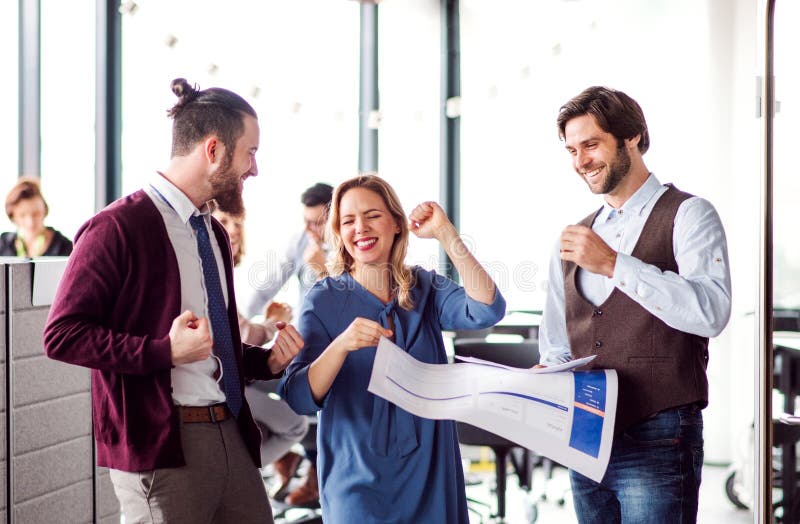 Group of Young Business People in an Office, Expressing Excitement ...