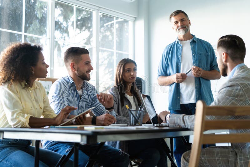 Group of Young Business People Working and Communicating while Sitting ...