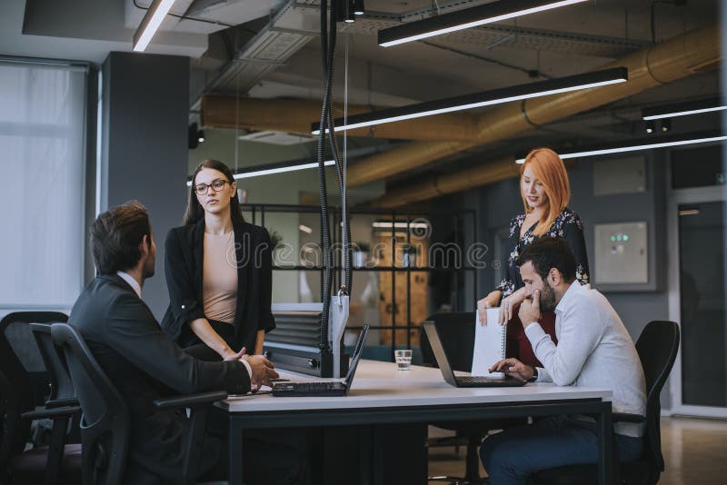 Group of Young Business People Working and Communicating Together in ...