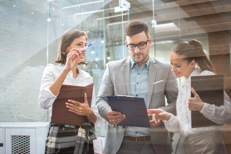 Group of Young Business People Working and Communicating Together in ...