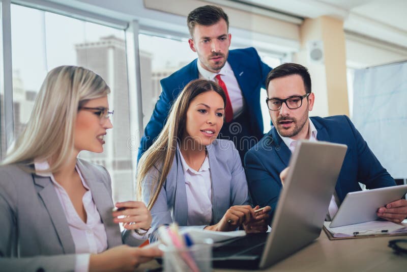 Group of Young Business People Working and Using Laptop while Sitting ...