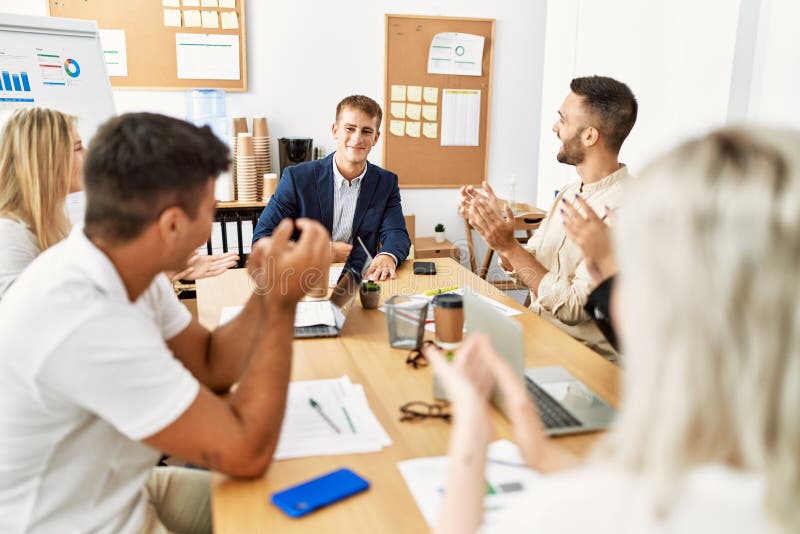 Group of Young Business Workers Smiling and Clapping To Partner at the ...