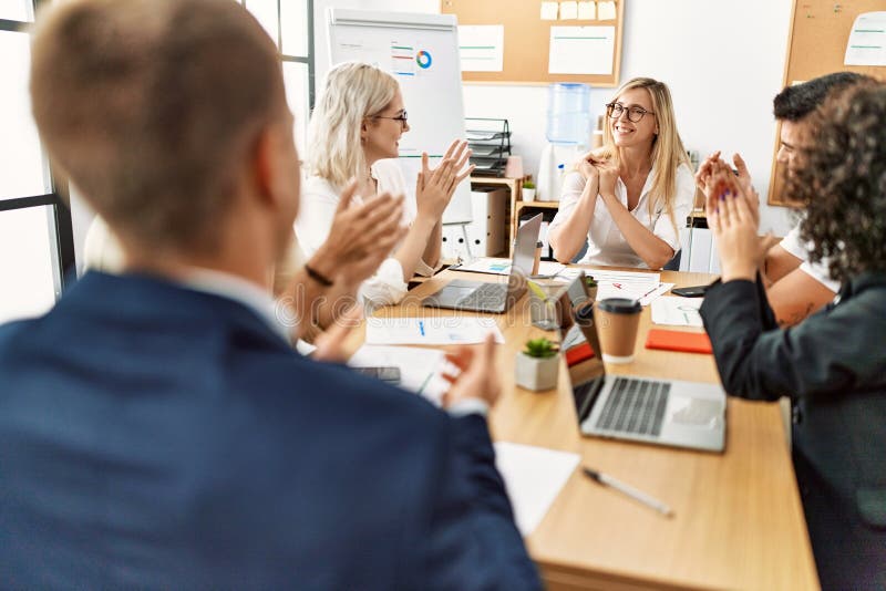 Group of Young Business Workers Smiling and Clapping To Partner at the ...