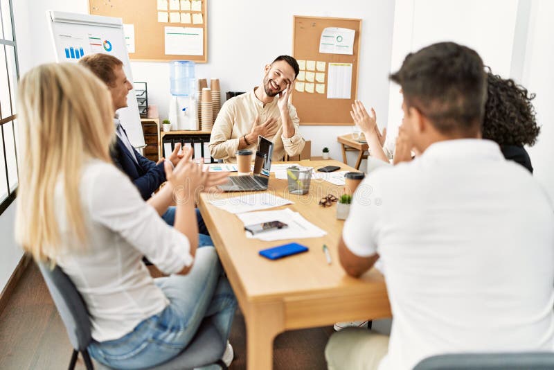 Group of Young Business Workers Smiling and Clapping To Partner at the ...