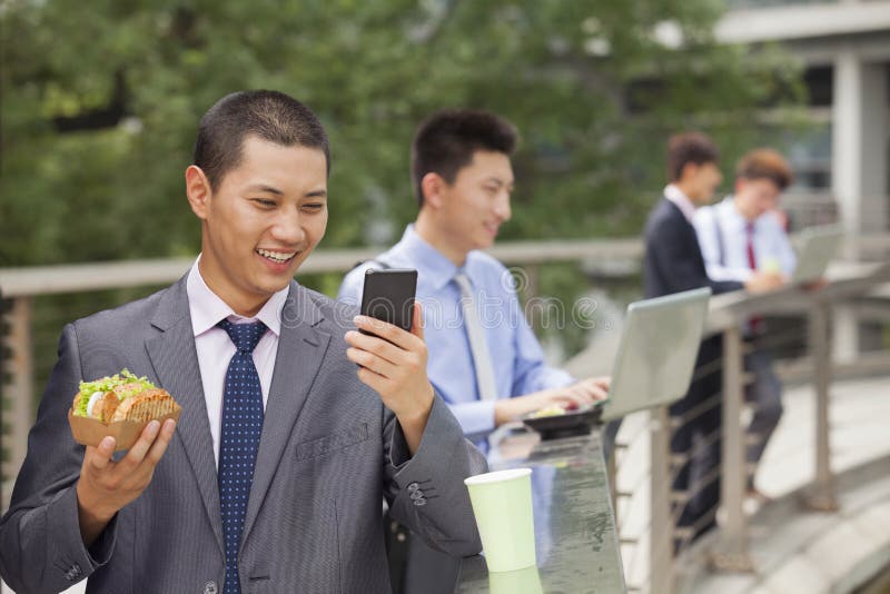 Group of Young Businessmen Working Outdoor and Eating Stock Image ...