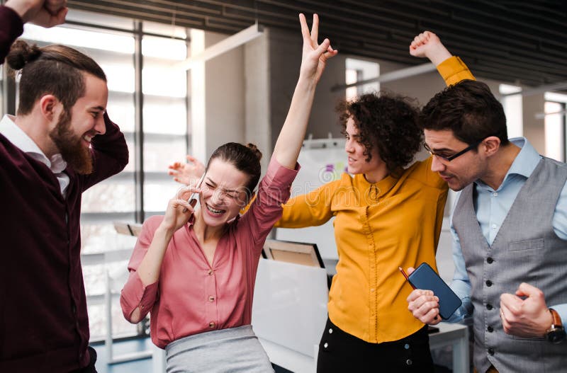A Group of Young Businesspeople with Smartphone Standing in Office ...
