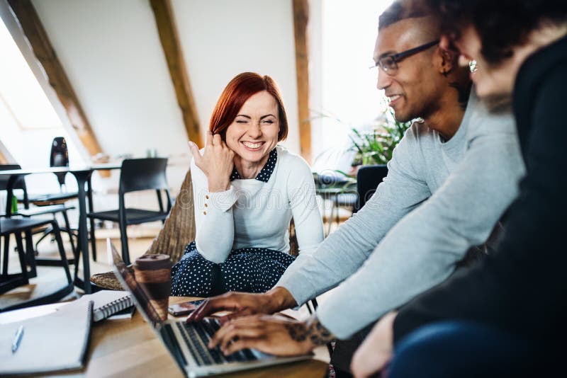 Group of Young Businesspeople Using Laptop in Office, Start-up Concept ...