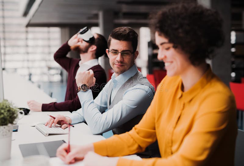A Group of Young Businesspeople with VR Goggles Working in Office ...