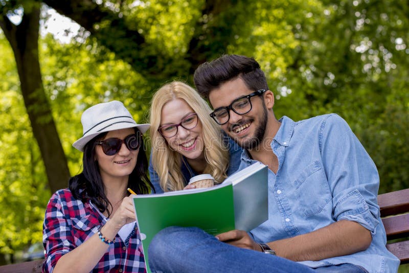 Group of Young Caucasian Friends Looking into Papers and Smiling Stock ...
