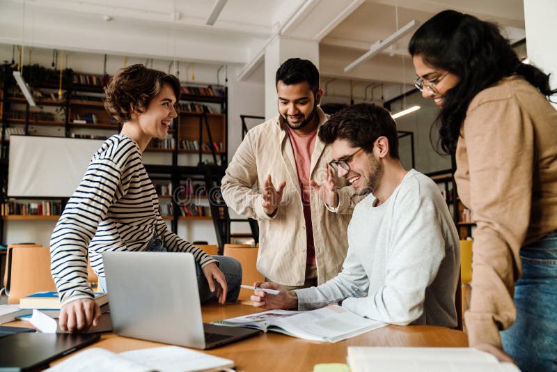 Group of Cheerful Students Having Discussion while Studying in College ...