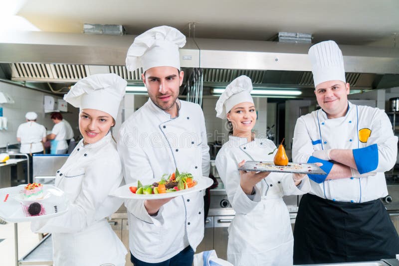 A Group of Young Chefs Posig with a Meal in Luxury Restaurant Stock ...