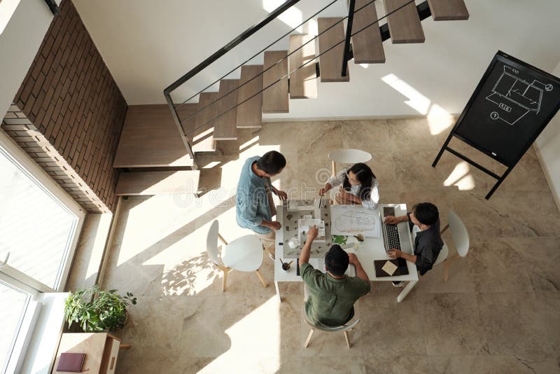 Group of Young Chinese Architects Gathered by Table for Discussion of ...