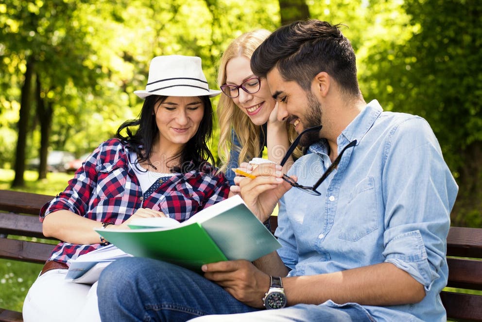 Group of Young College Students Having Fun while Discussing Homework on ...