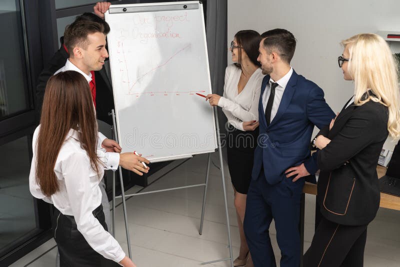 Group of Young Confident Bisiness People Analyzing Data Using Office ...