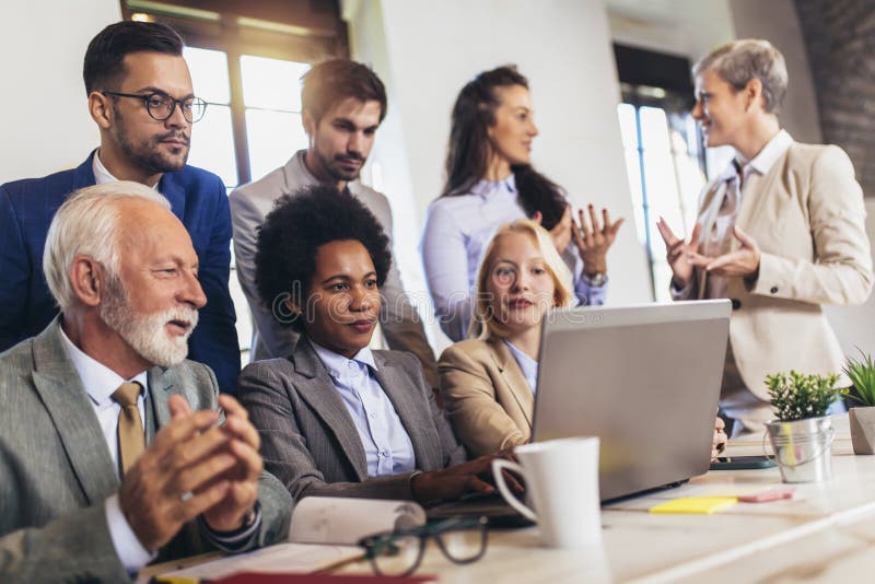 Young Confident Business People Analyzing Data Using Computer while ...