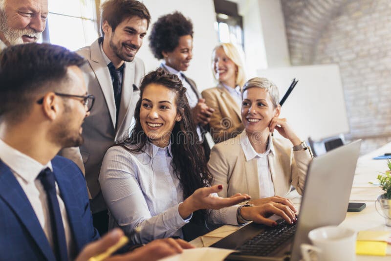 Young Confident Business People Analyzing Data Using Computer while ...