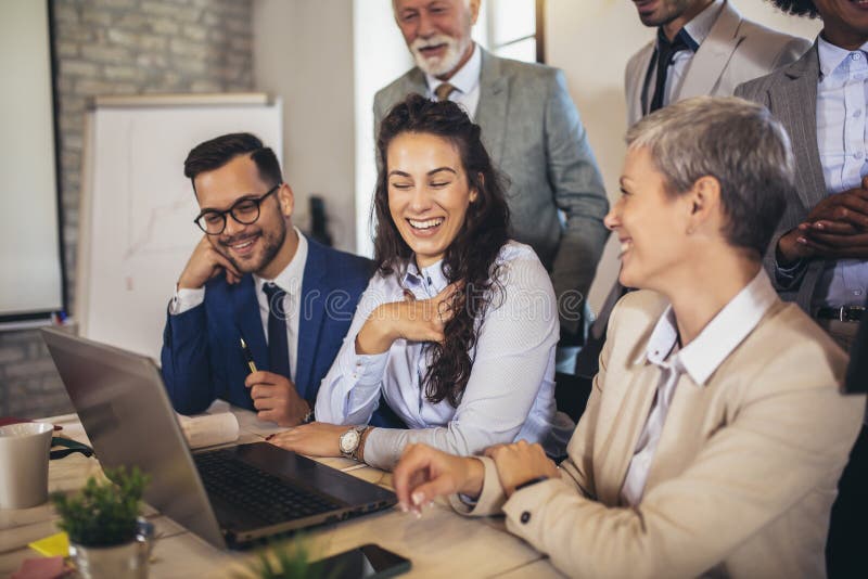 Young Confident Business People Analyzing Data Using Computer while ...