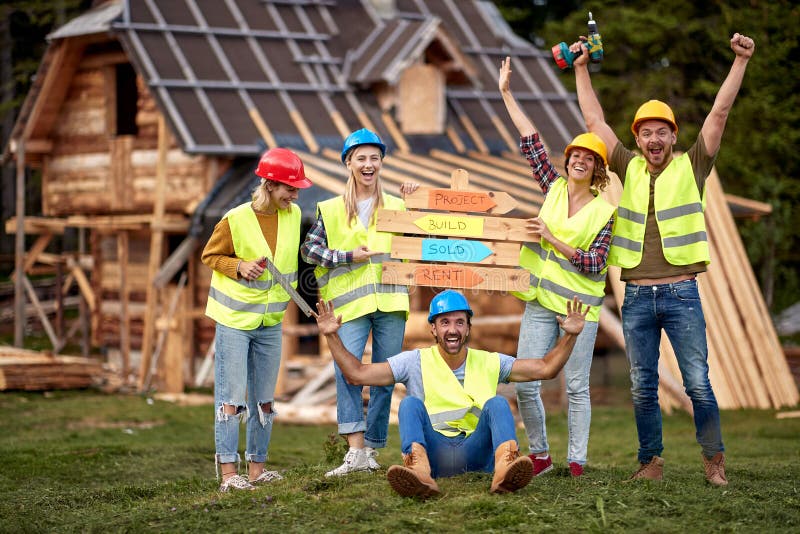 Group of Young Constructive Workers Cheering in Front of Wooden House ...