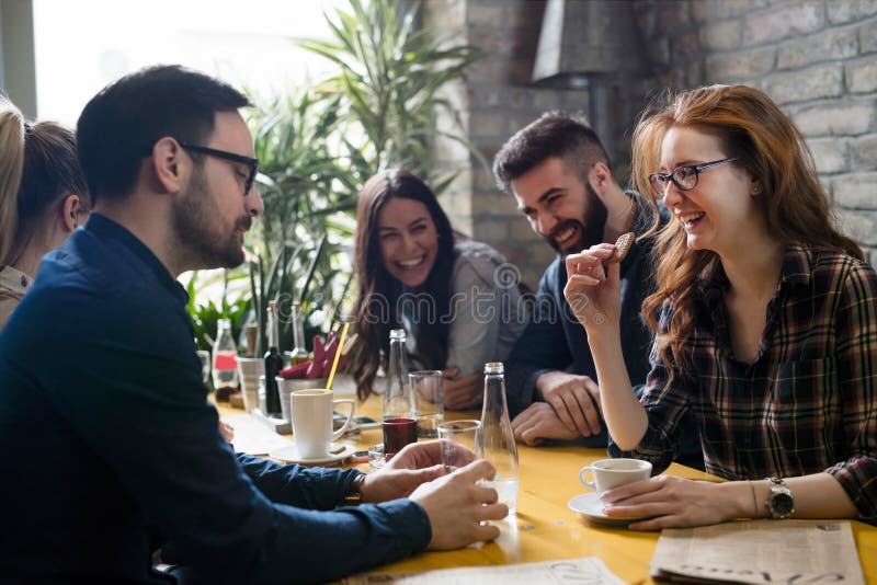 Group of Young Coworkers Socializing in Restaurant Stock Photo - Image ...
