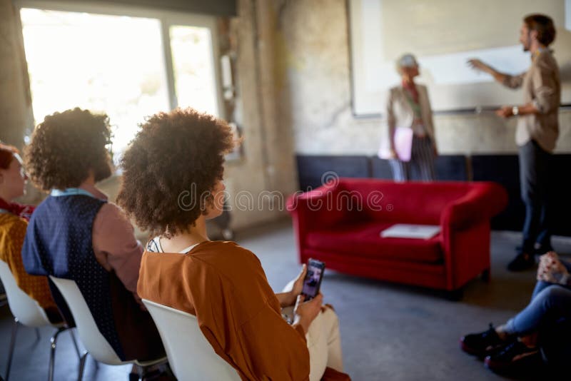 Group of Young Creative People is Following a Lecture in the Office ...