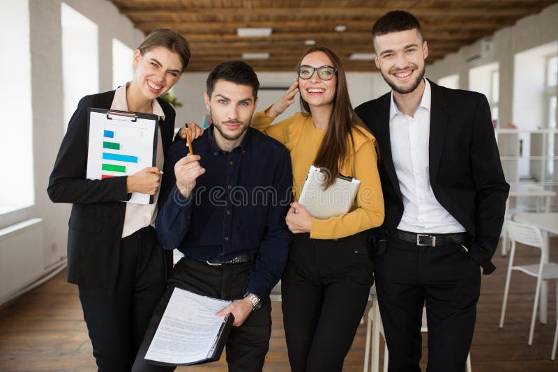 Group of Young Creative People in Suits Happily Looking in Camera ...