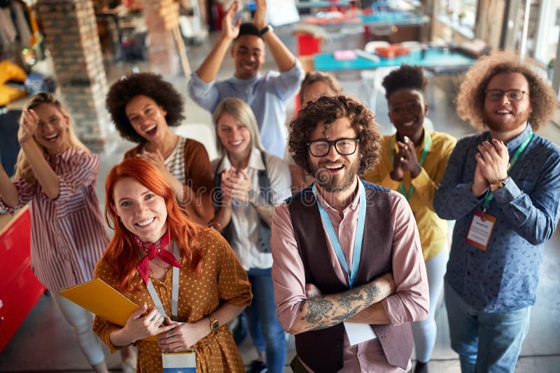 Group of Young Creative People at Work is Clapping and Yelling while ...