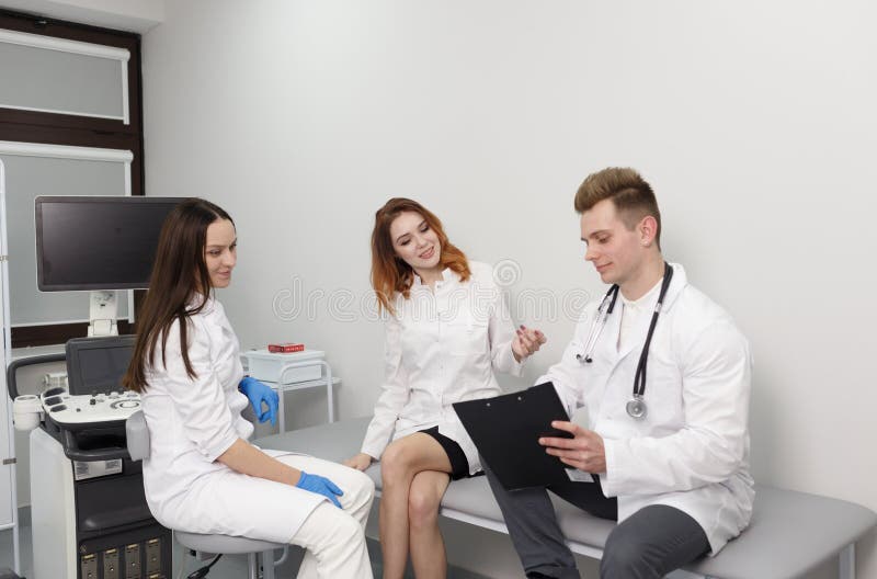 A Group of Young Doctors Communicate with Each Other Sitting in the ...