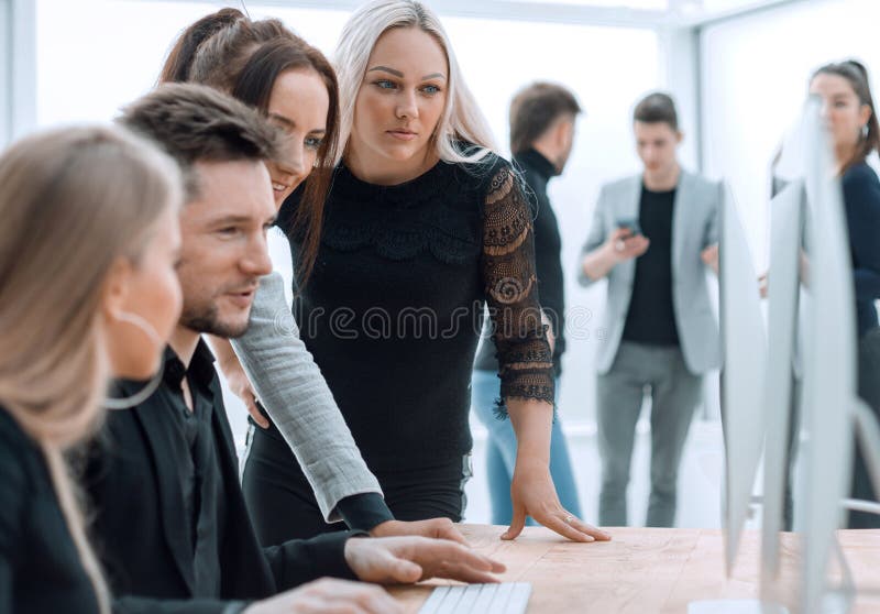 Group of Young Employees Looking at the Screens of Office Computers ...