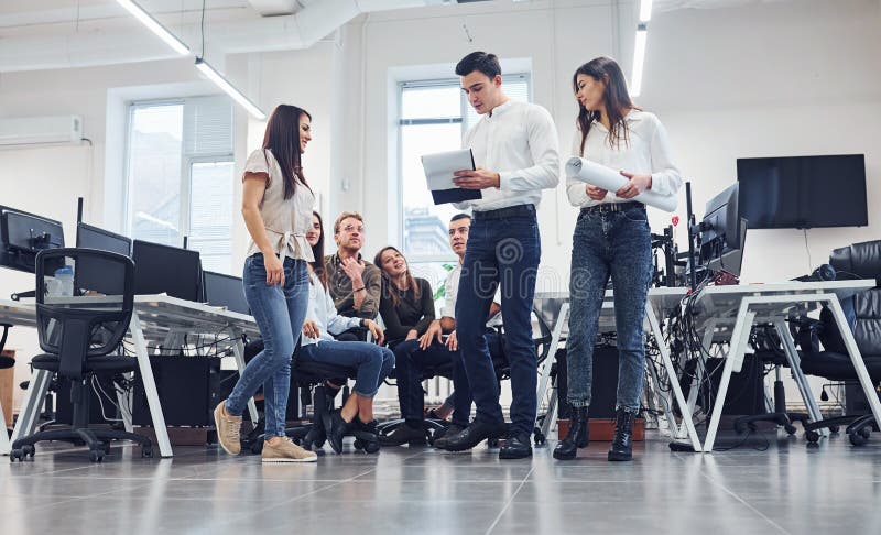 Group of Young Employees Talking and Working at New Project in the ...