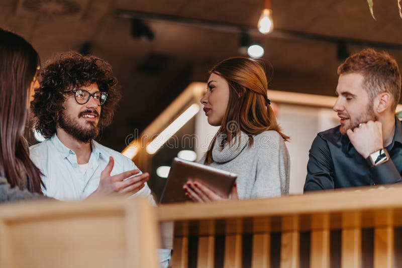 A Group of Young Entrepreneurs on a Coffee Break Discuss the Project ...
