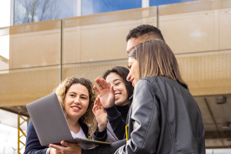 Group of Young Entrepreneurs Making a Video Call on a Laptop Outdoors ...
