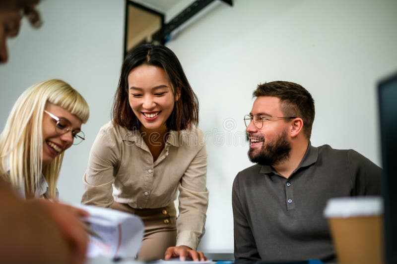 Young Entrepreneurs Working on a Computer and Plans in the Office Stock ...