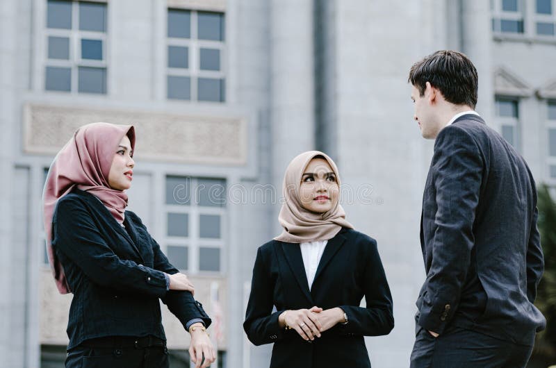Group of Young Executive People in Formalwear Discussing Something and ...